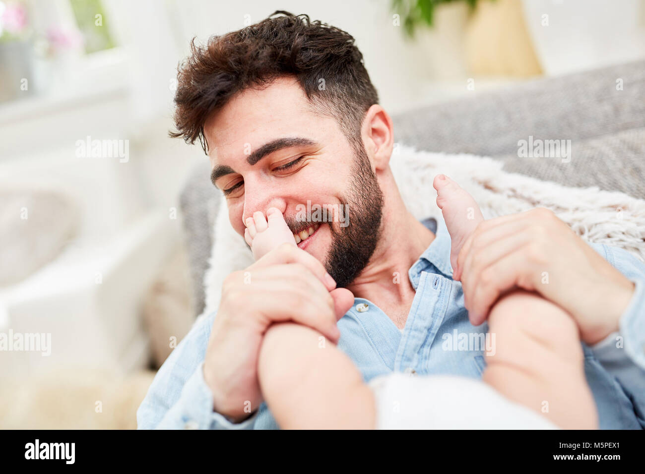Happy father plays and cuddles with his newborn baby Stock Photo - Alamy