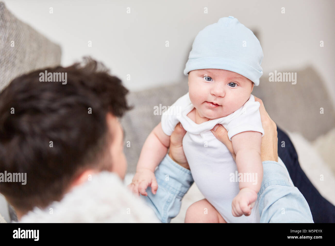 Newborn male baby in the arms of his father Stock Photo - Alamy