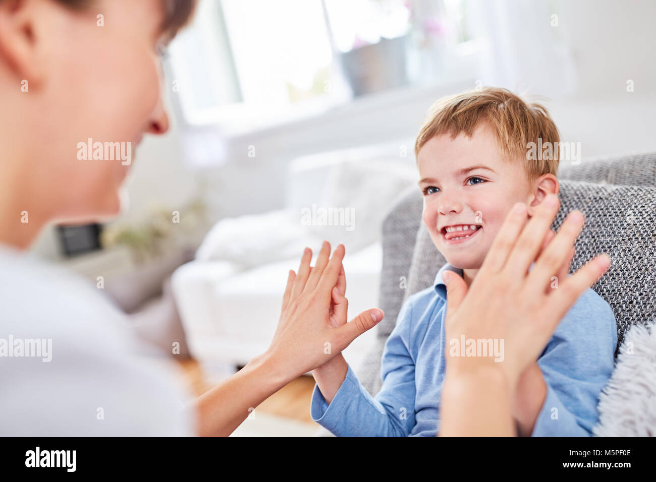 Happy boy has fun gossiping with mother Stock Photo - Alamy