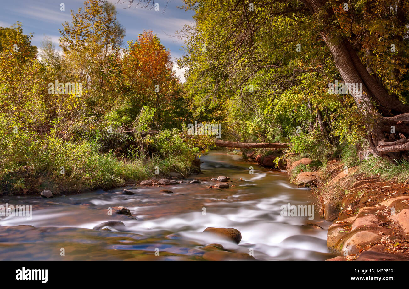 A fast running stream taken with a long exposure to create a milky ...