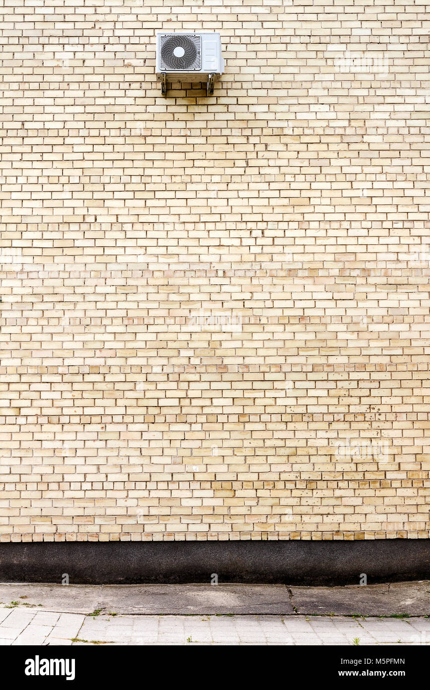 Big fragment of yellow brick wall with air conditioner. Architecture ...