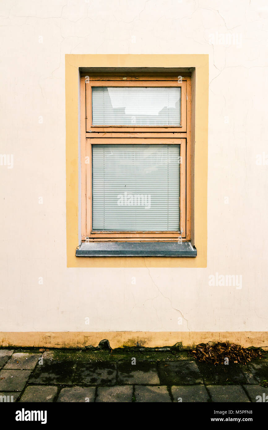 Yellow plaster wall with a window. Architecture detail background Stock ...
