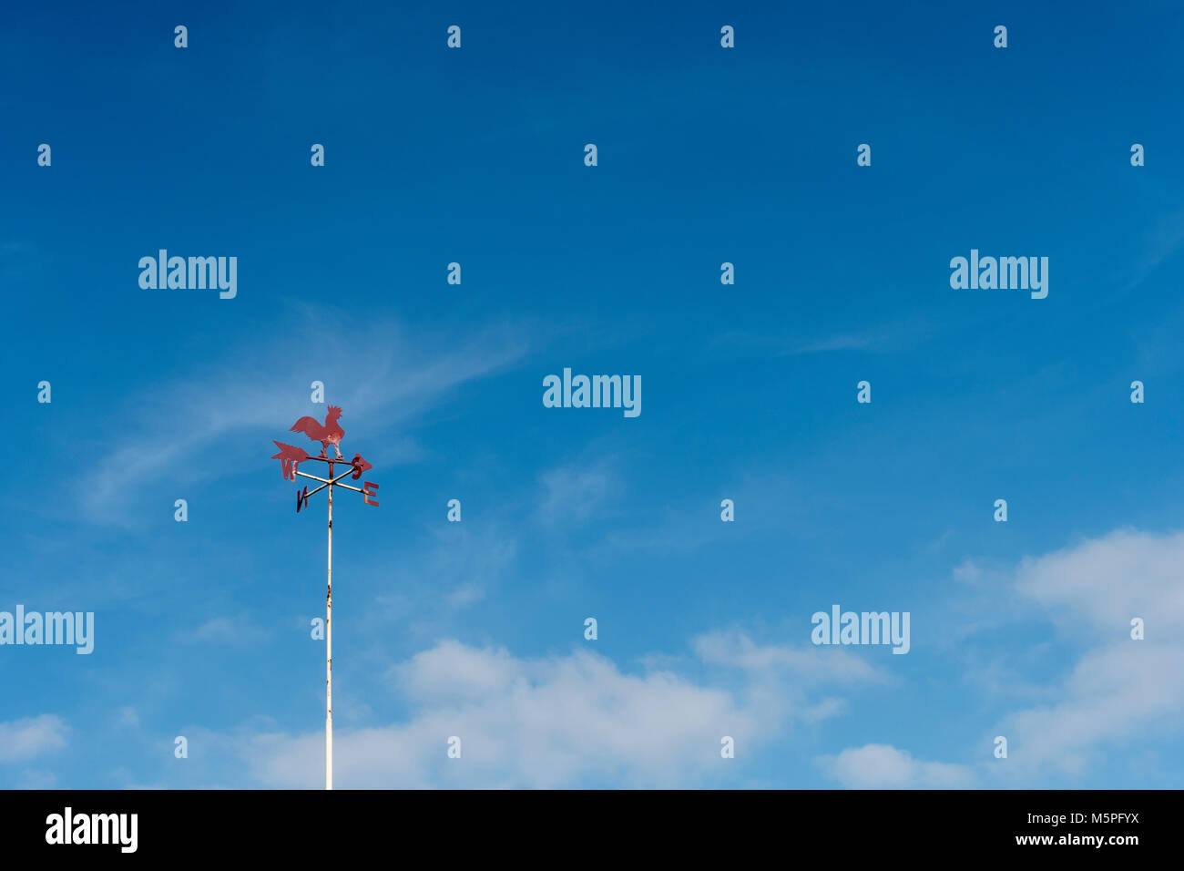 Wind vane set against bright blue sky - metaphor for business direction ...