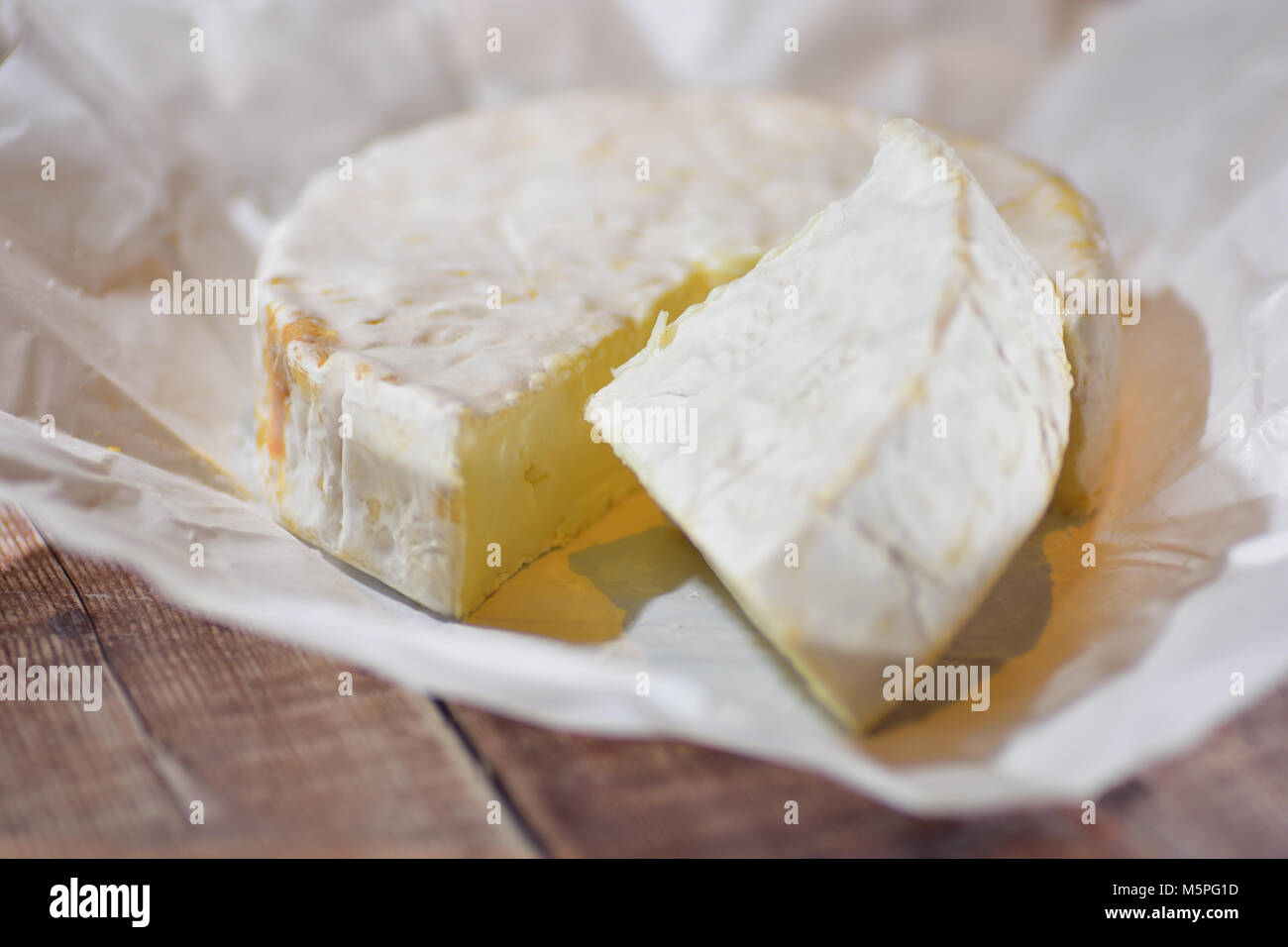Goats Cheese fresh with the wrapper Stock Photo - Alamy