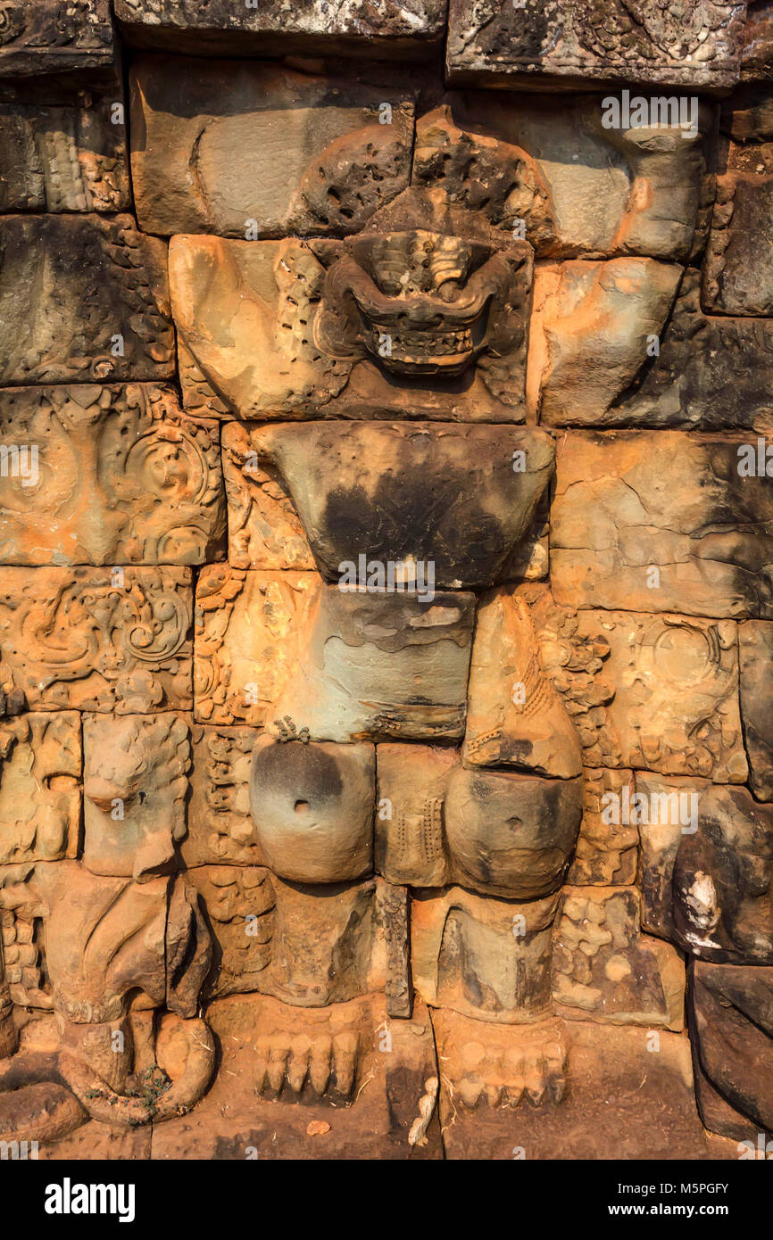 Yaksha demon image in stone wall in Cambodia Stock Photo - Alamy