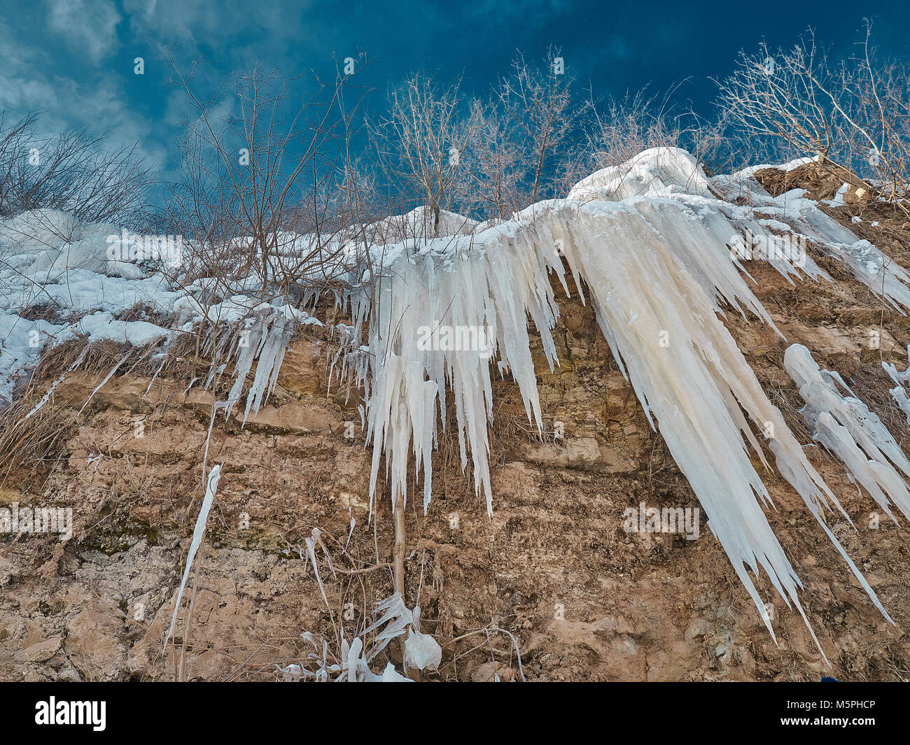 Huge blocks of ice hanging from the cliff. The beauty of the wild Stock ...