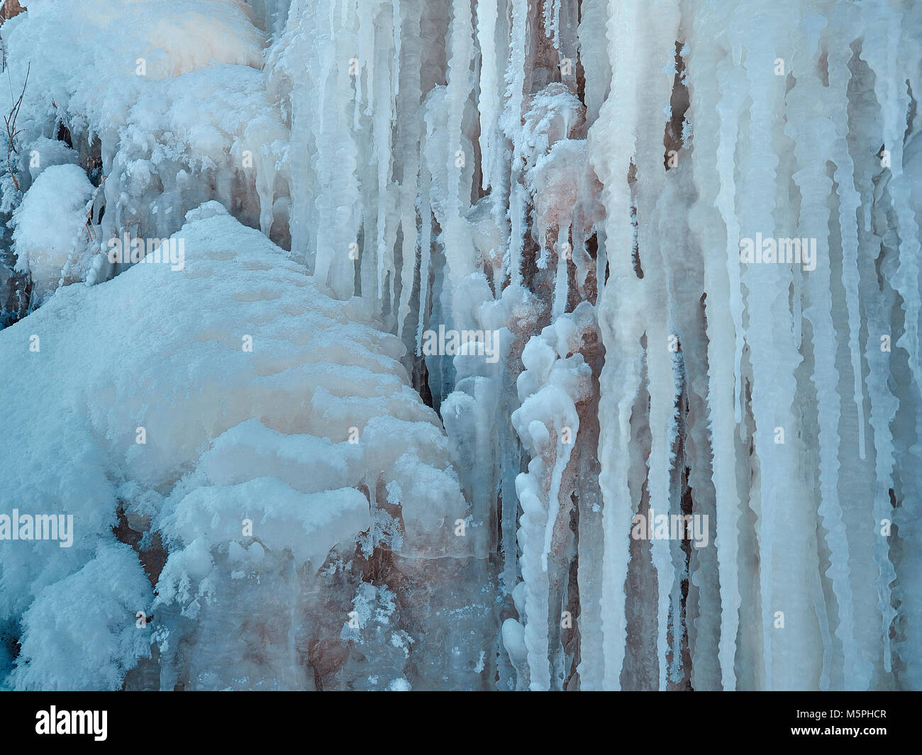 Huge blocks of ice hanging from the cliff. The beauty of the wild Stock ...