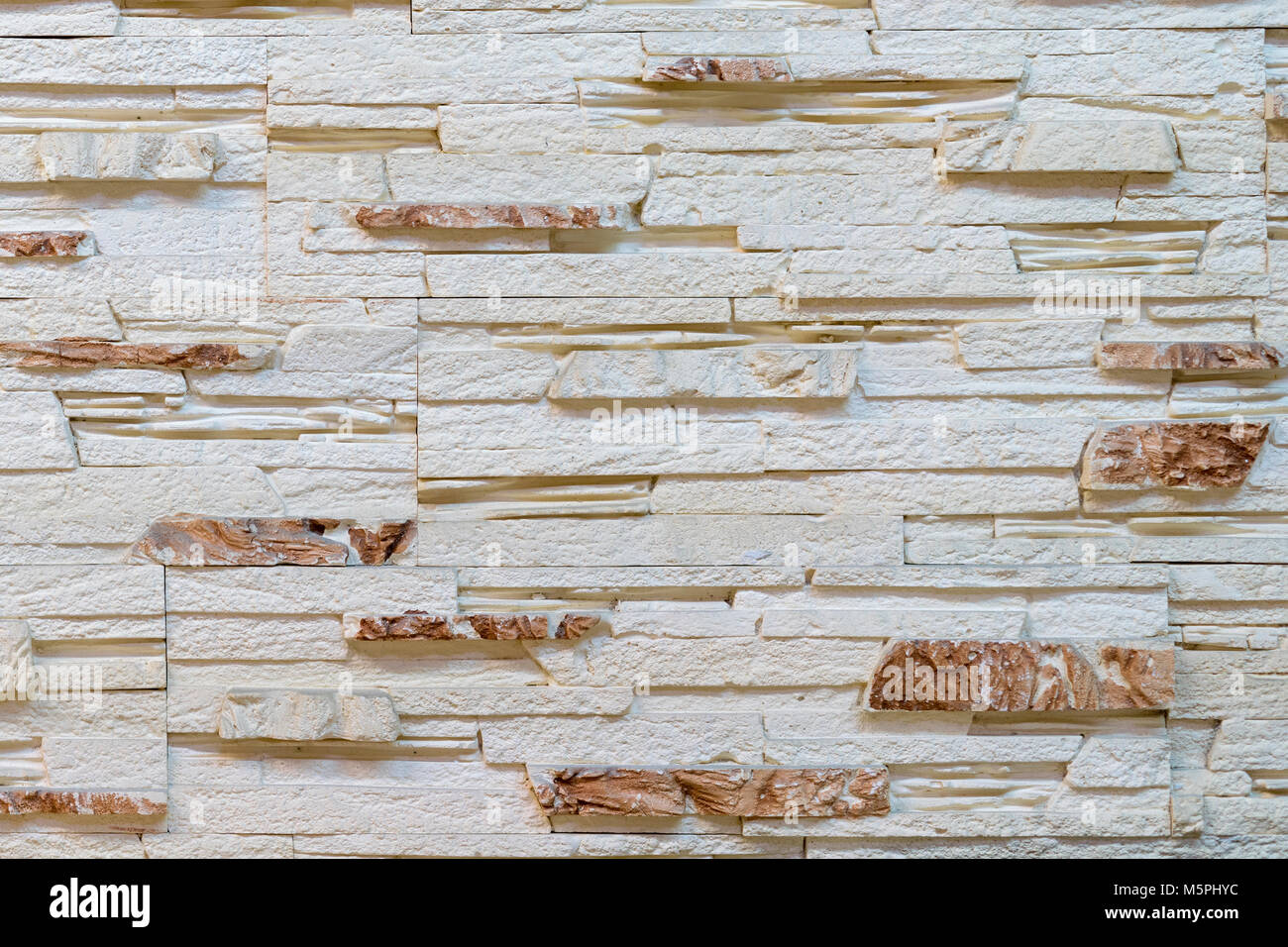 Wall made of decorative light brown stone. Decorating for the fireplace ...