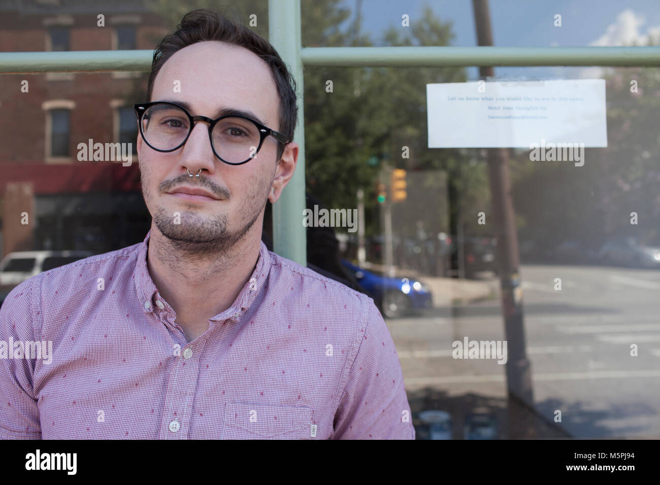 Young Man in front of shop window Stock Photo - Alamy
