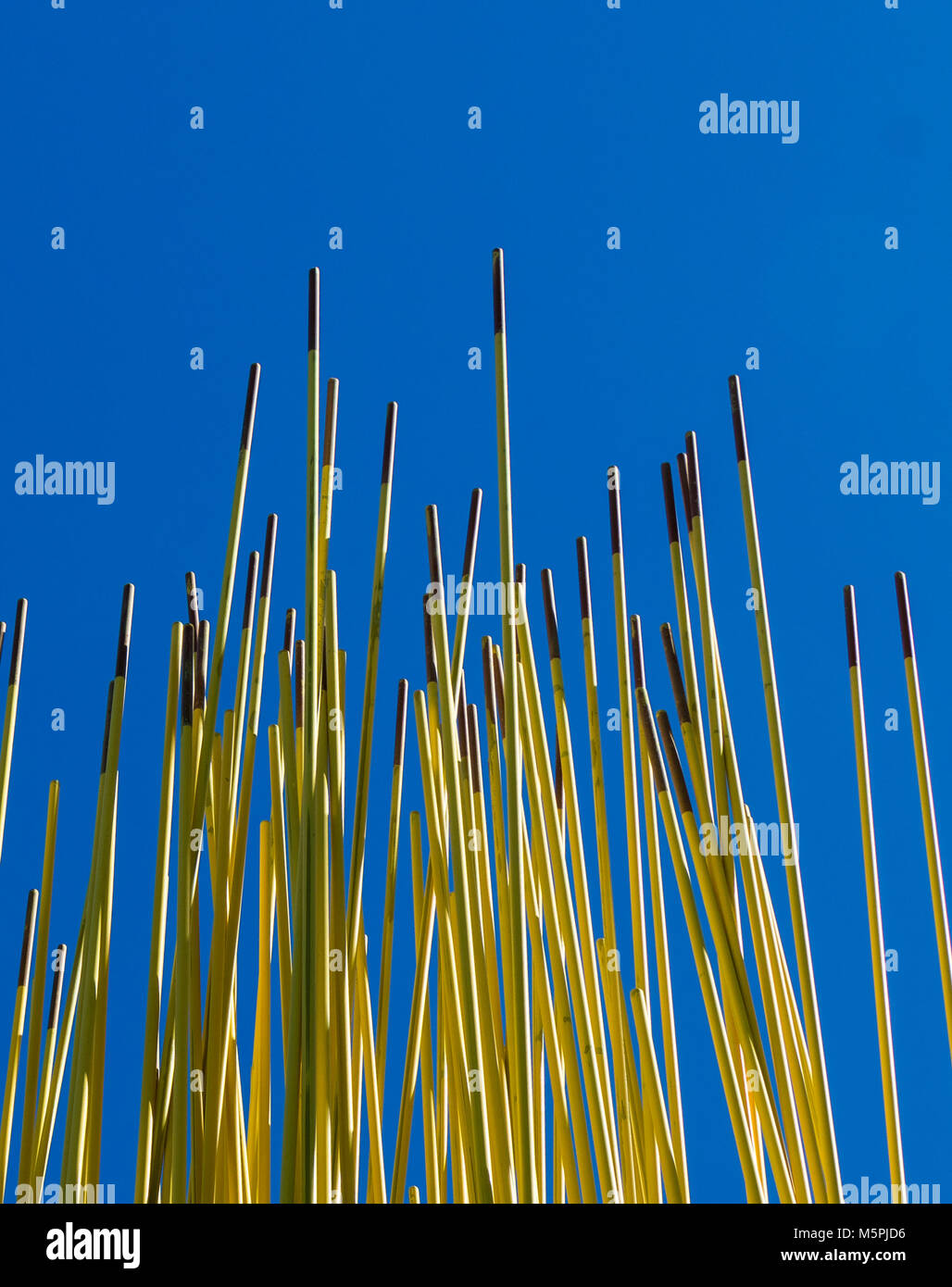 Yellow steel rods with a blus sky background Stock Photo - Alamy