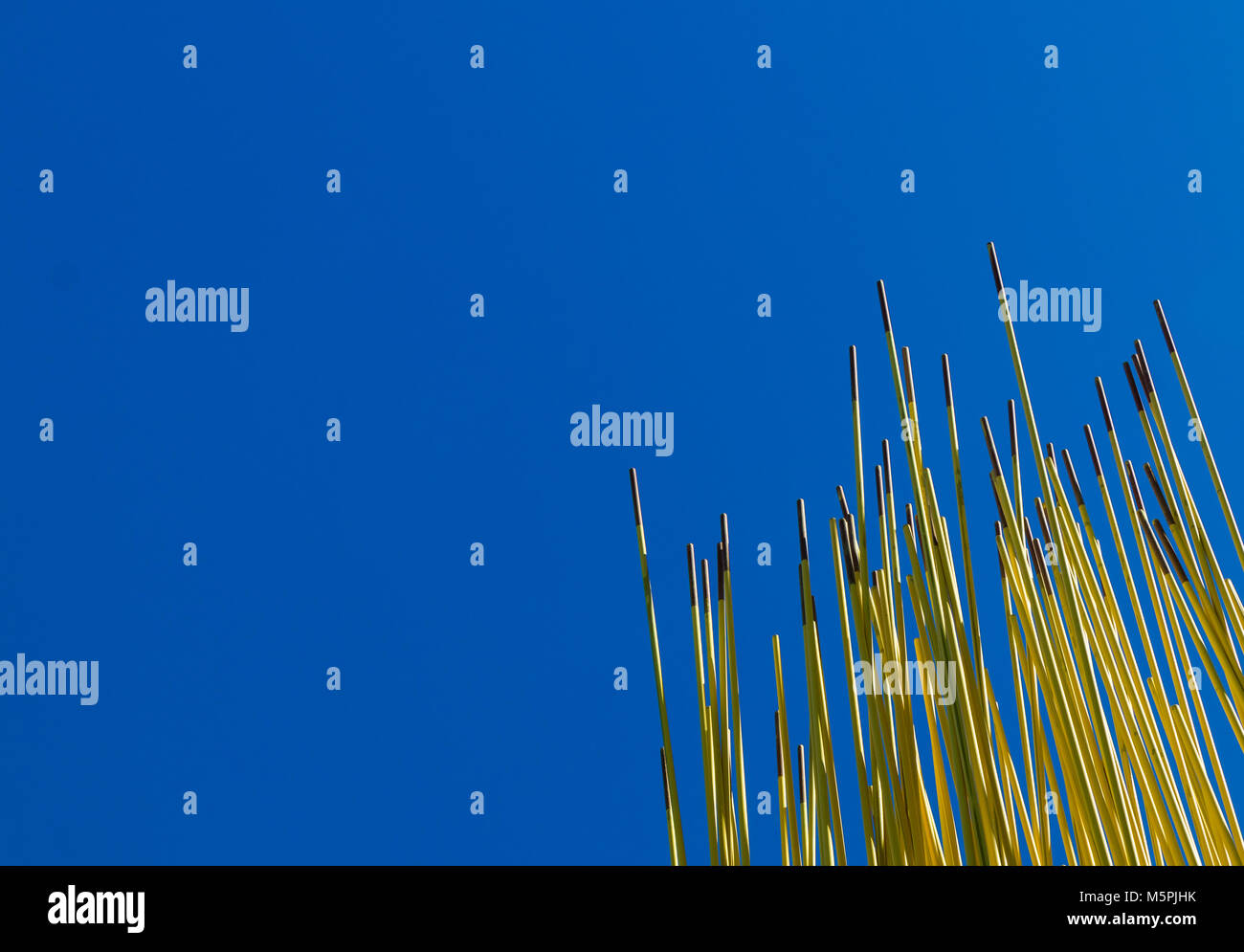 Yellow steel rods with a blus sky background Stock Photo - Alamy