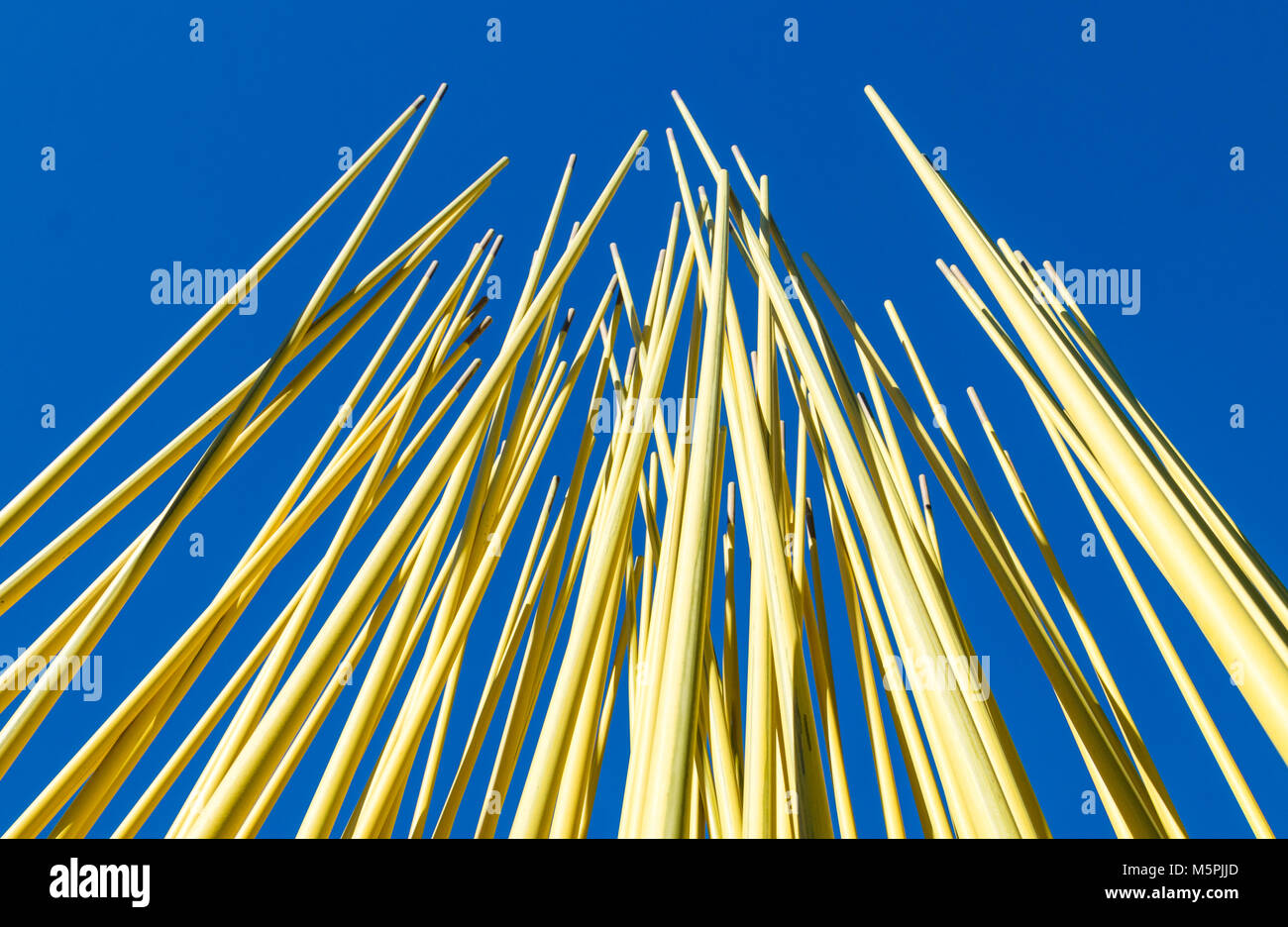 Yellow steel rods with a blus sky background Stock Photo - Alamy
