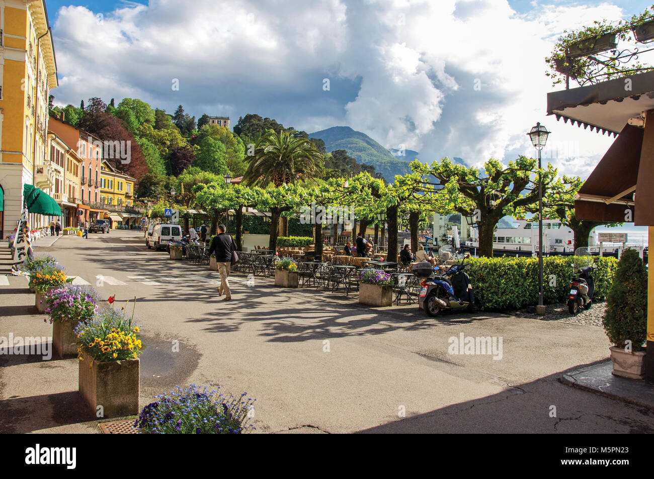 Como, Italy. View of people walking on street along the shore of Lake ...