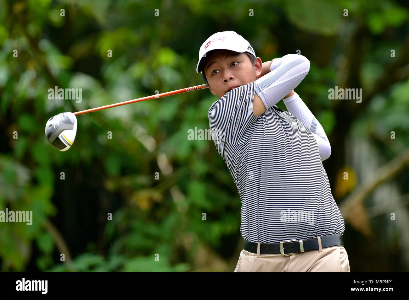 Danau, UKM Bangi - FEBRUARY 11: Haziq Iman Imran watches his tee shot ...