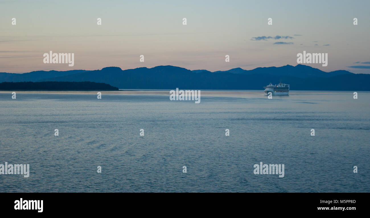 Dawn on Glacier Bay, Alaska with mountain range, and cruise ship on the ...