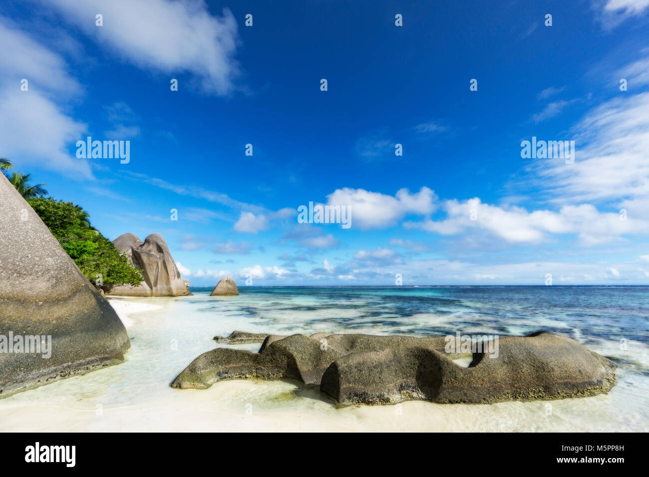 amazing picturesque paradise beach. granite rocks,white sand,palm trees ...