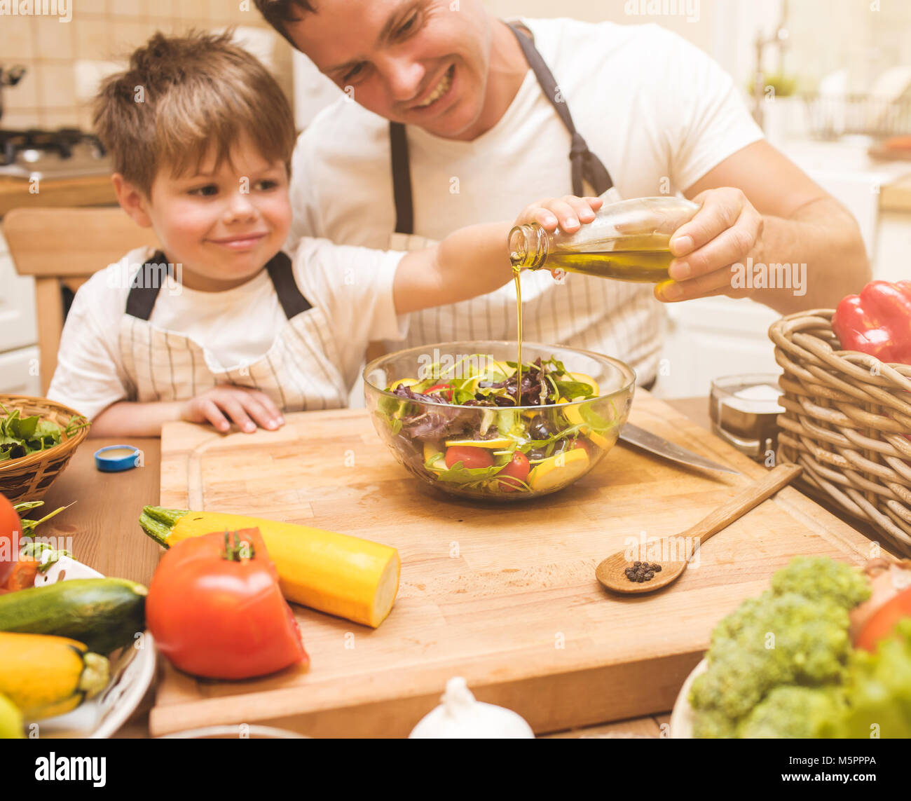 Father is cooking with his son Stock Photo - Alamy