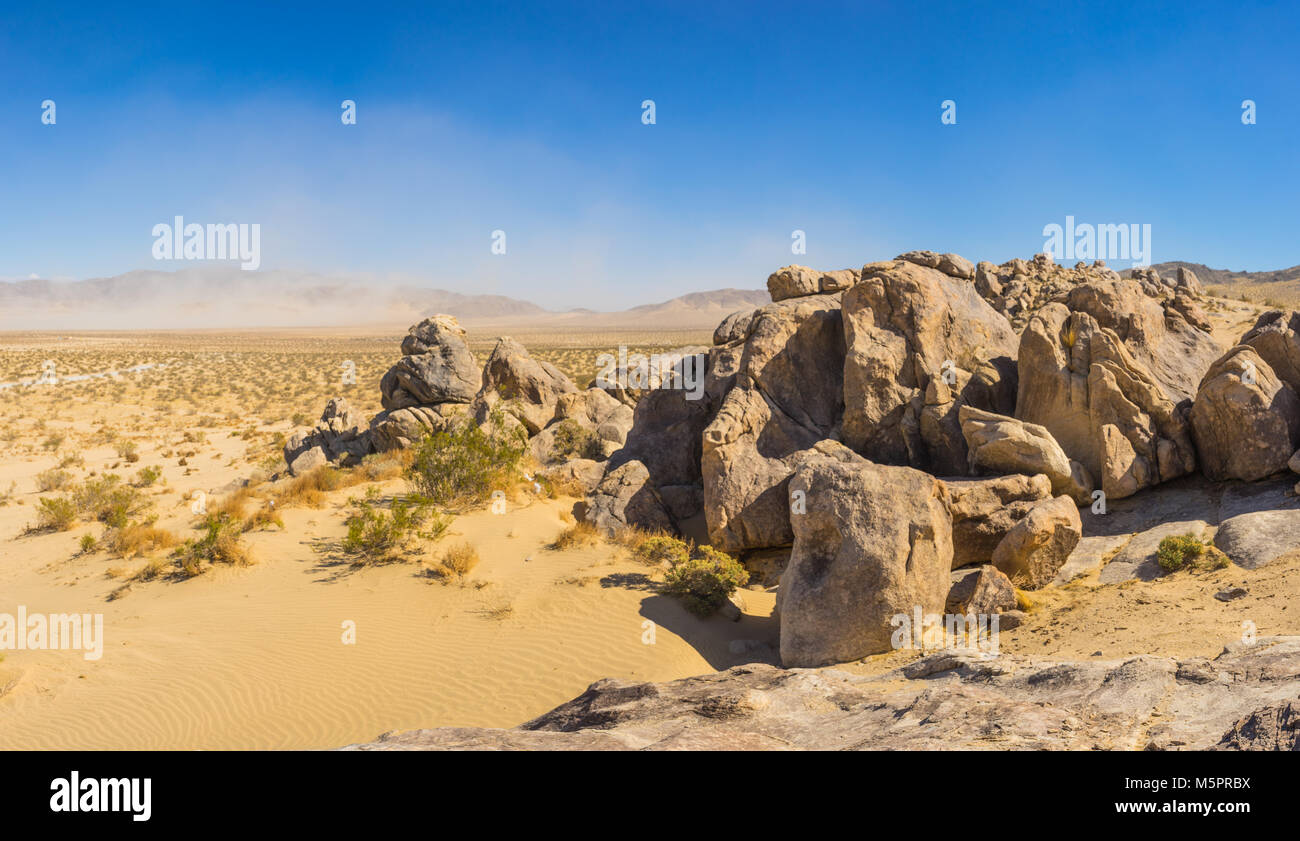 Panorama of boulders above a vast plain of sand and desert in southern ...