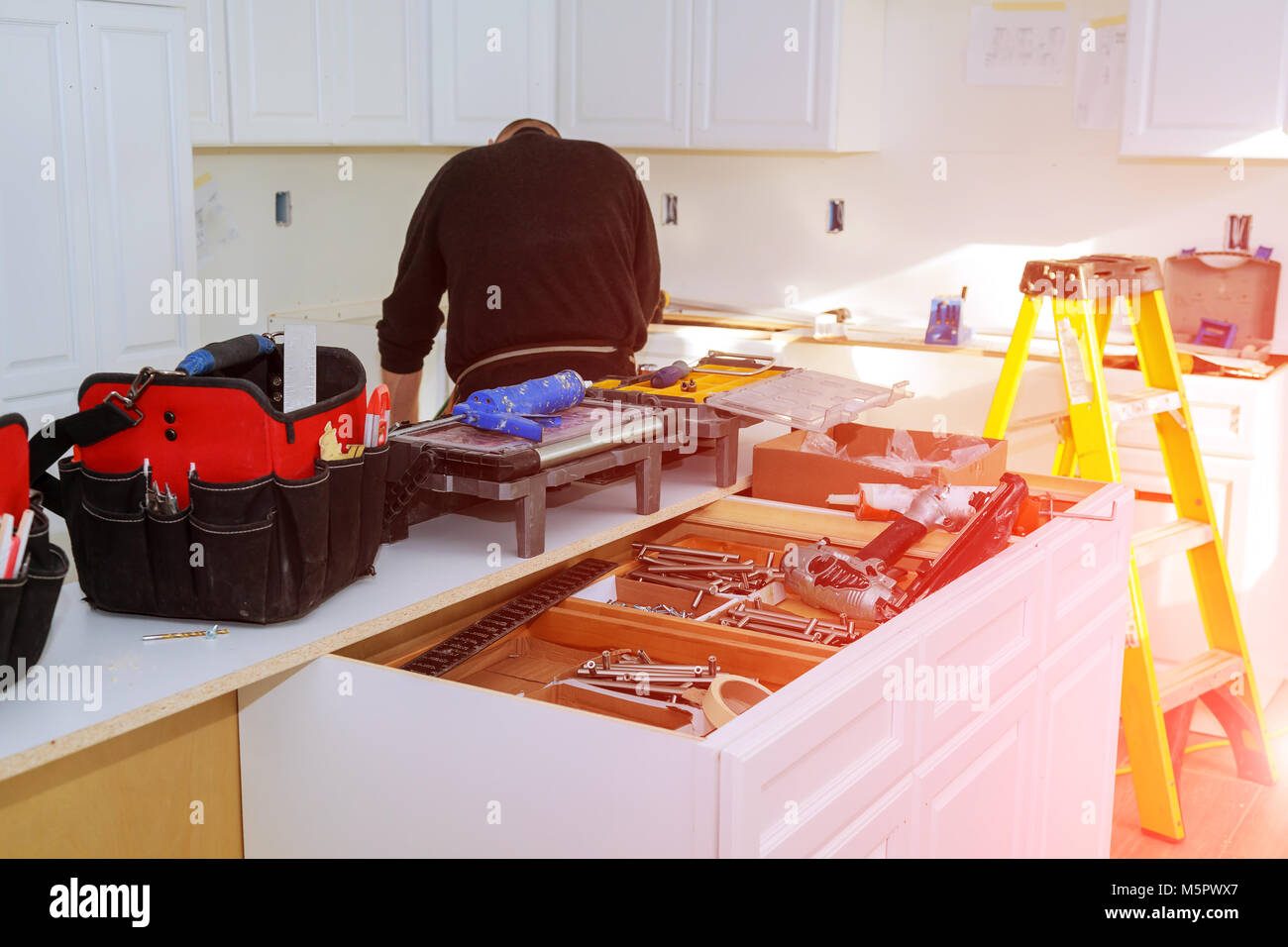 Installation of kitchen. Custom kitchen cabinets in various stages of ...