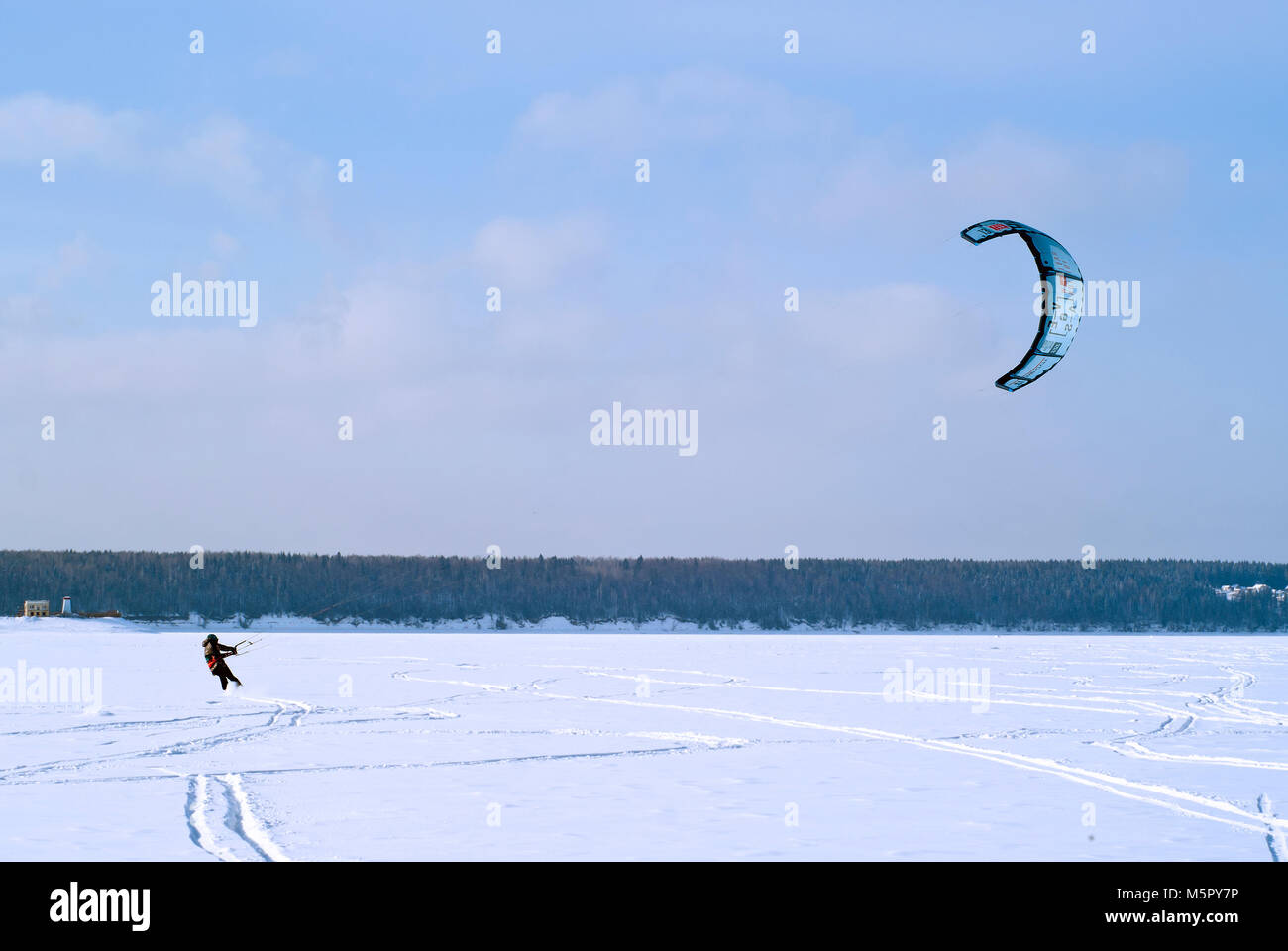 PERM, RUSSIA - FEBRUARY 23, 2018: snowkiter glides on the ice of the ...