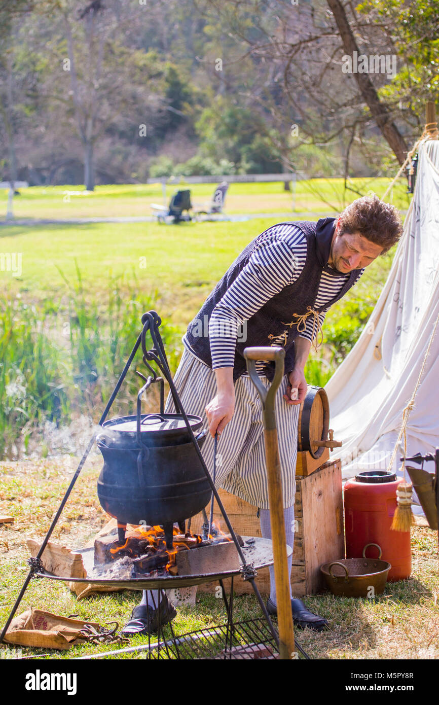 A man in period dress at a American Revolution reenactment cooking ...