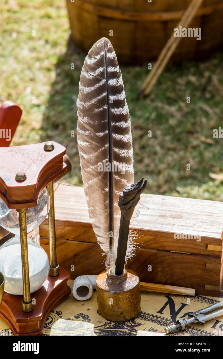 A quill pen in a ink pot beside a old sand glass and pipe Stock Photo ...