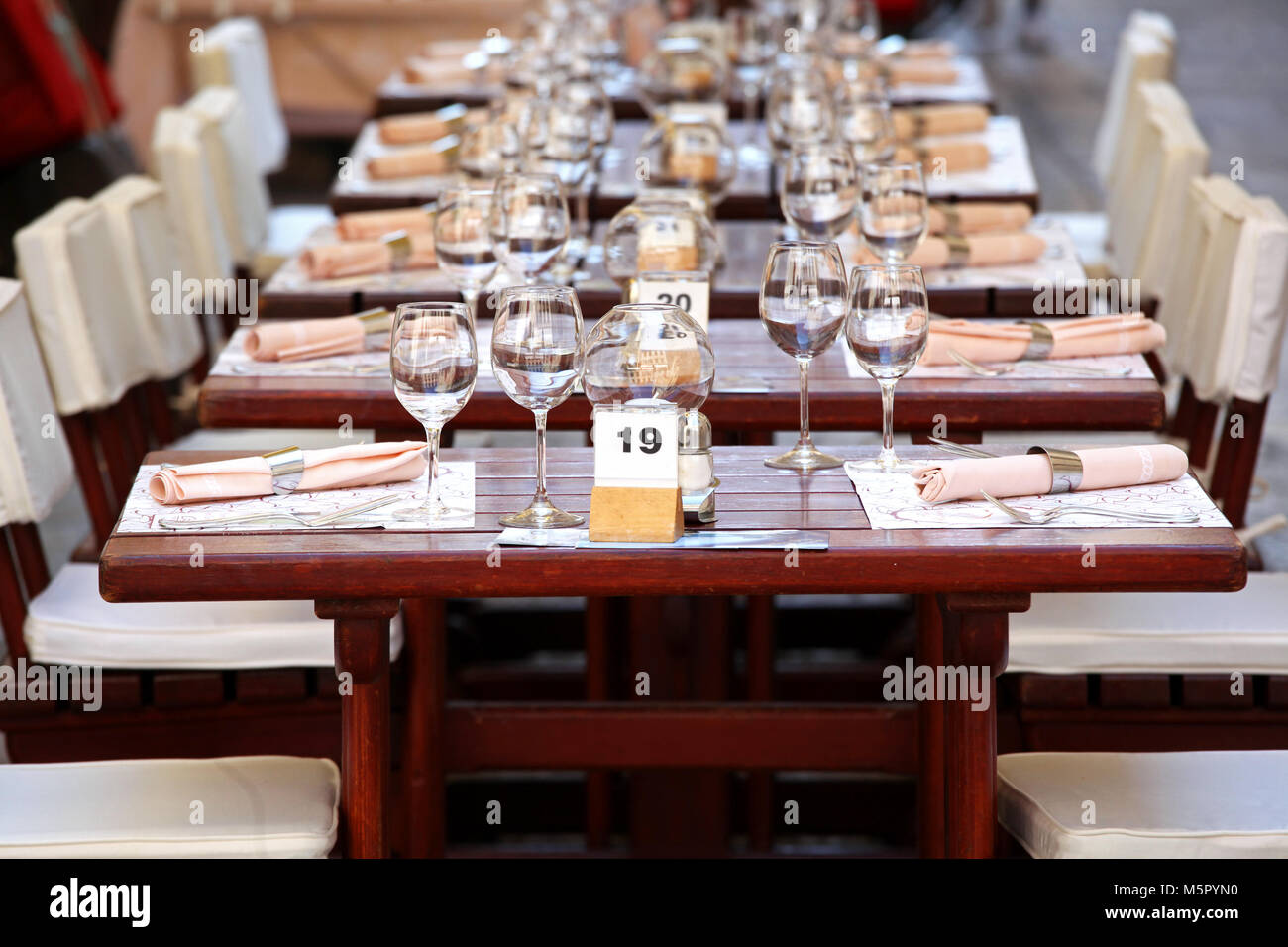 Row of tables in restaurant outside terrace Stock Photo - Alamy