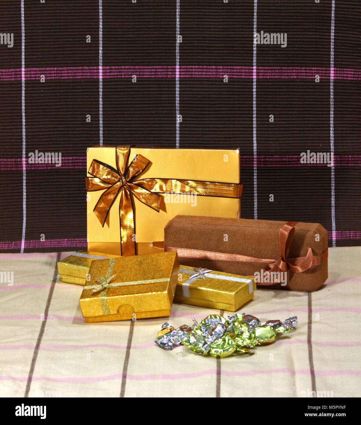 Present and chocolate boxes with gold ribbon Stock Photo - Alamy