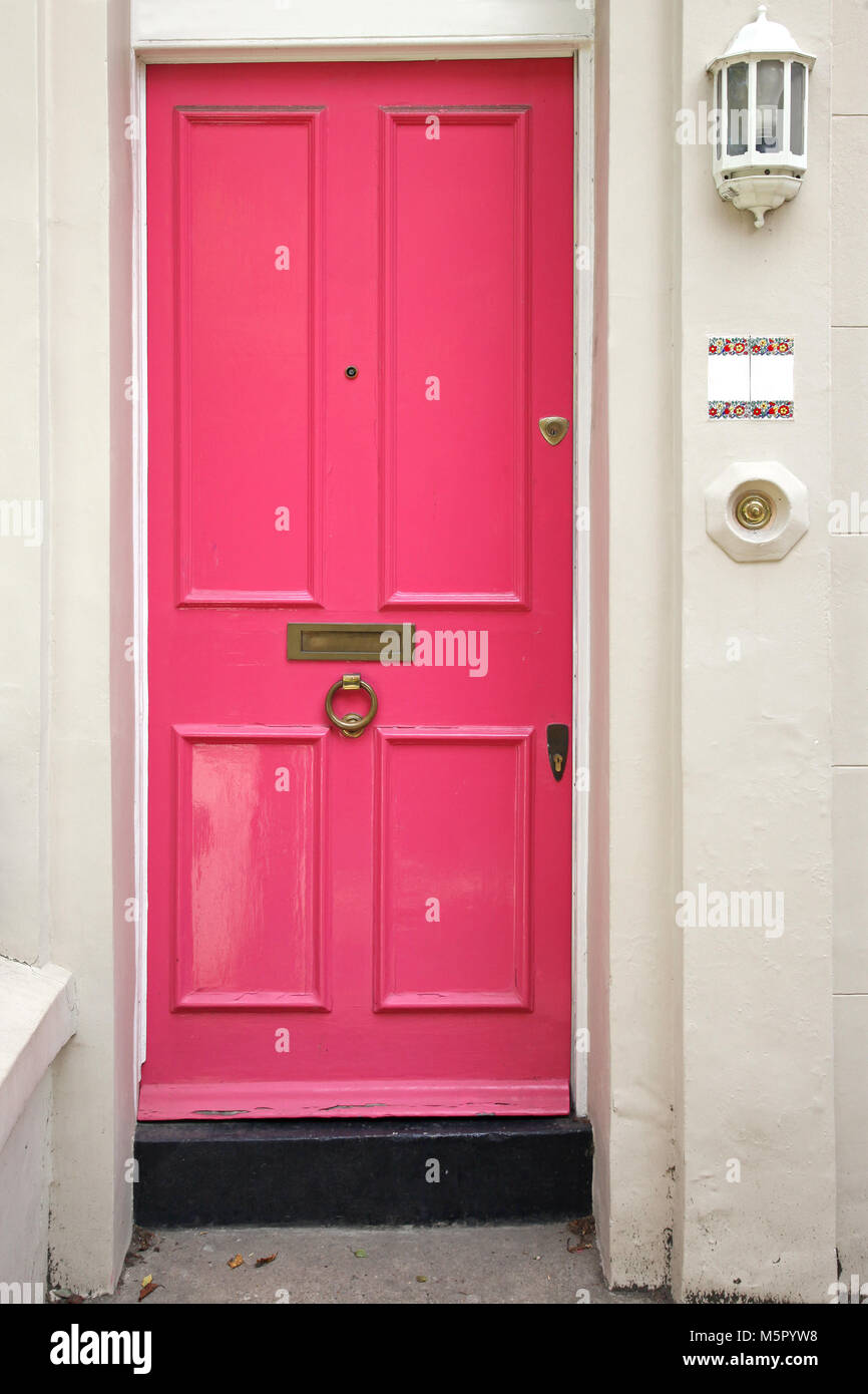 Pink entrance door in front of residential house Stock Photo - Alamy