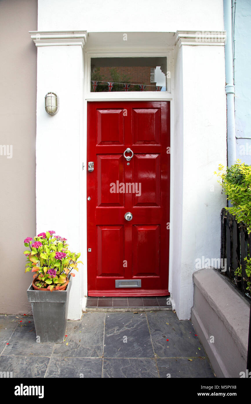 Red entrance door in front of residential house Stock Photo - Alamy