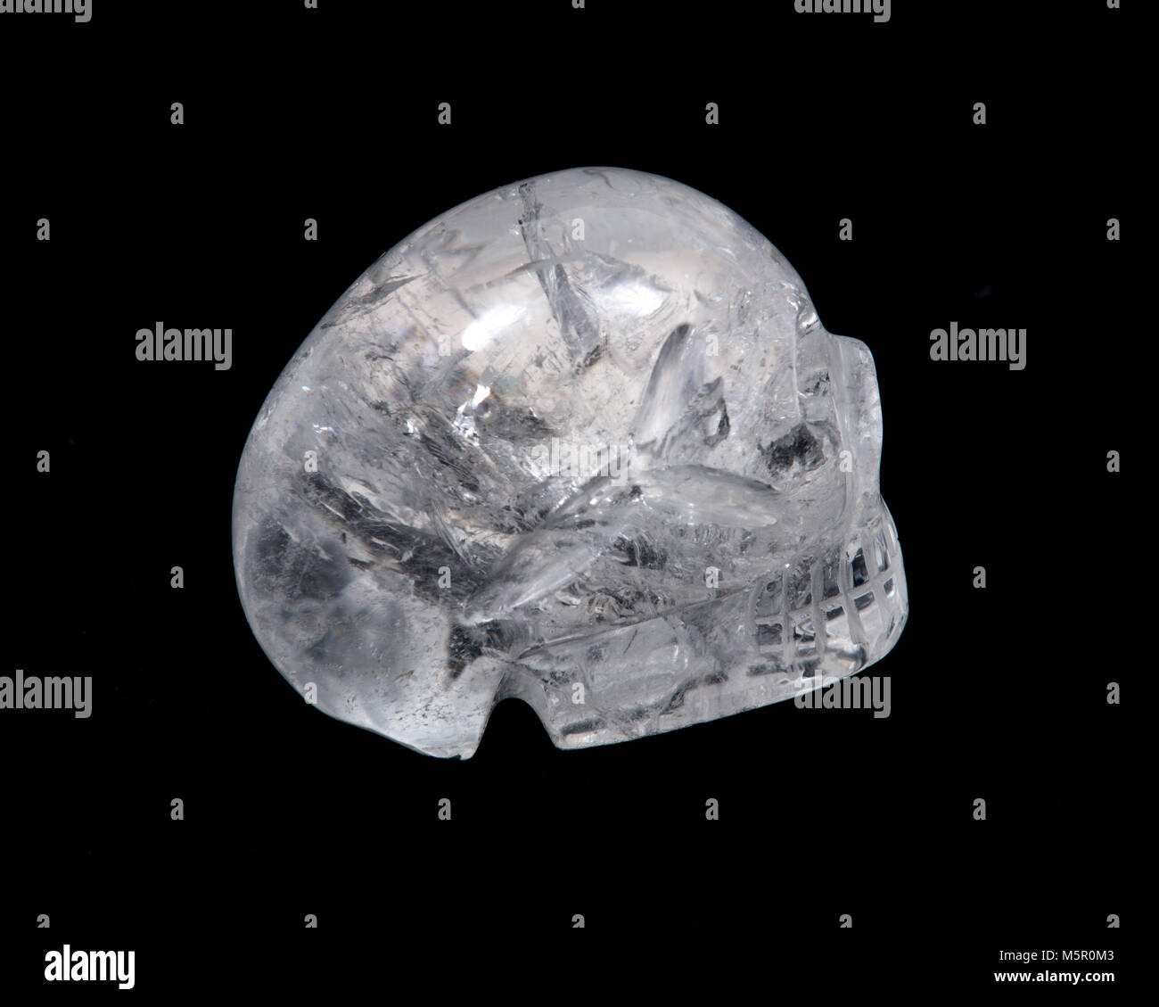 Clear quartz skull with rainbow on black background Stock Photo - Alamy