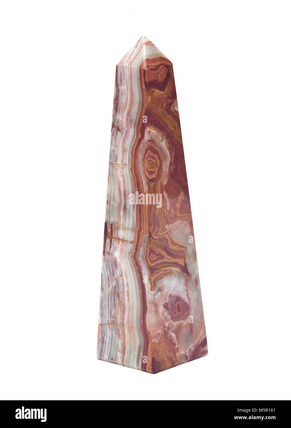 Polished multicolor carved onyx obelisk isolated on white background ...