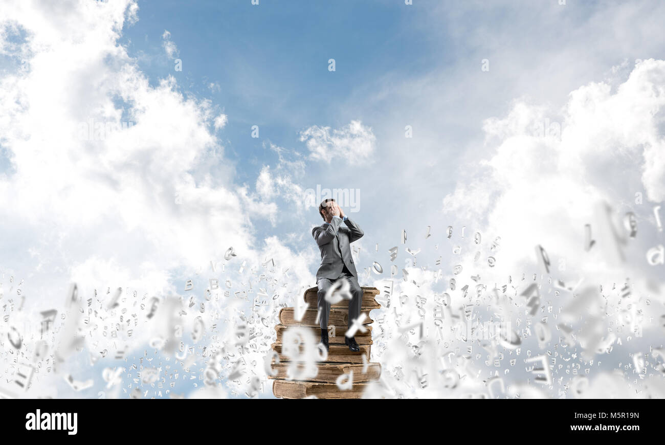 Young man floating in sky and do not want to see anything Stock Photo ...