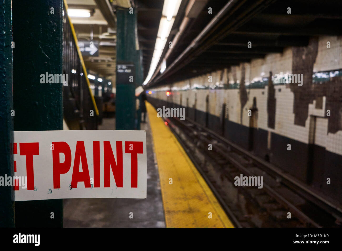 wet paint sign at the subway platform Stock Photo - Alamy