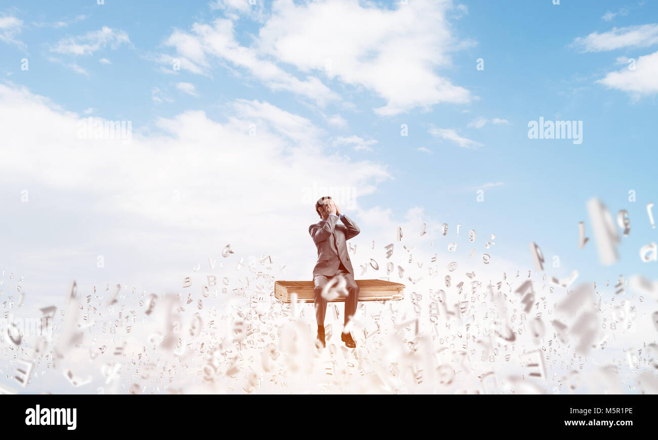 Young man floating in sky and do not want to see anything Stock Photo ...