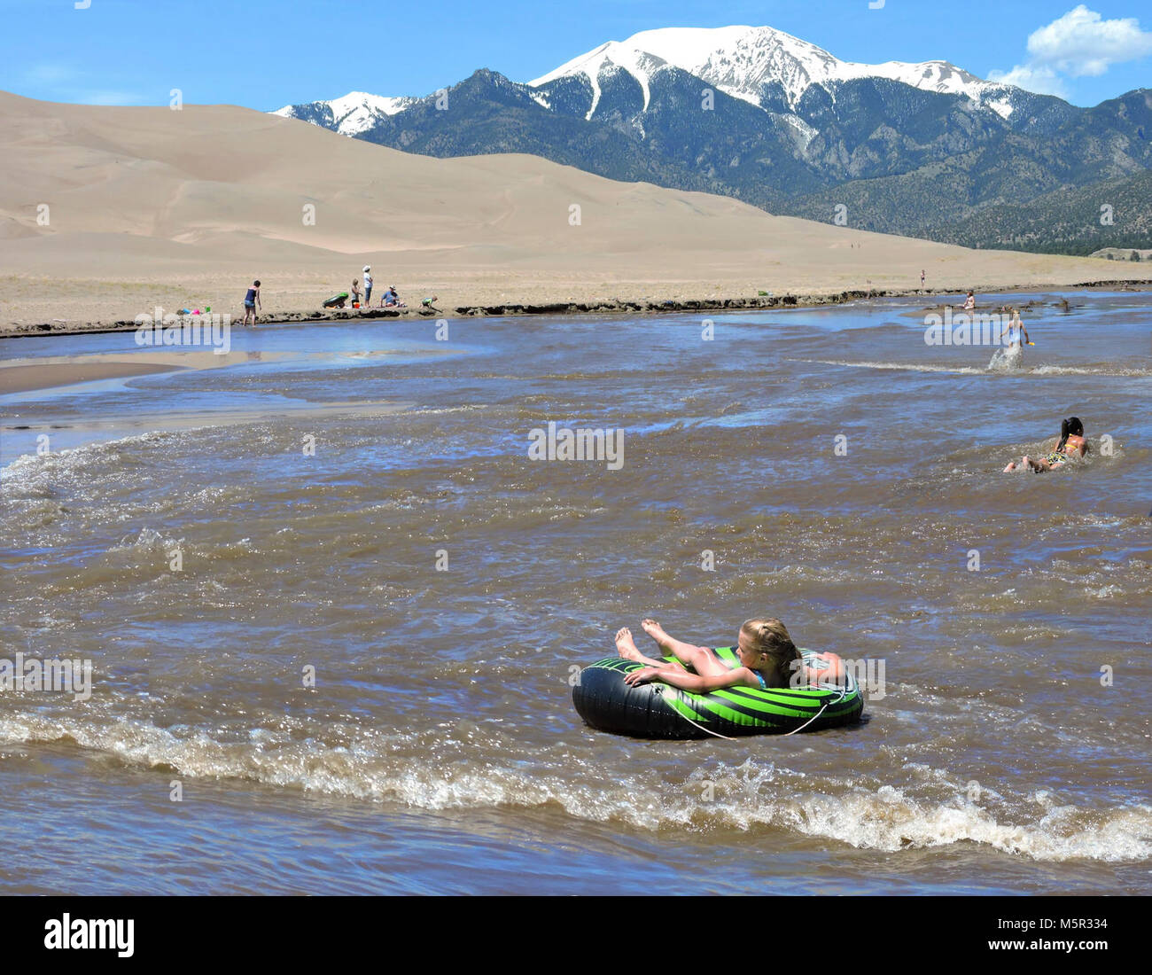 Girl Tubing Medano Creek Stock Photo - Alamy