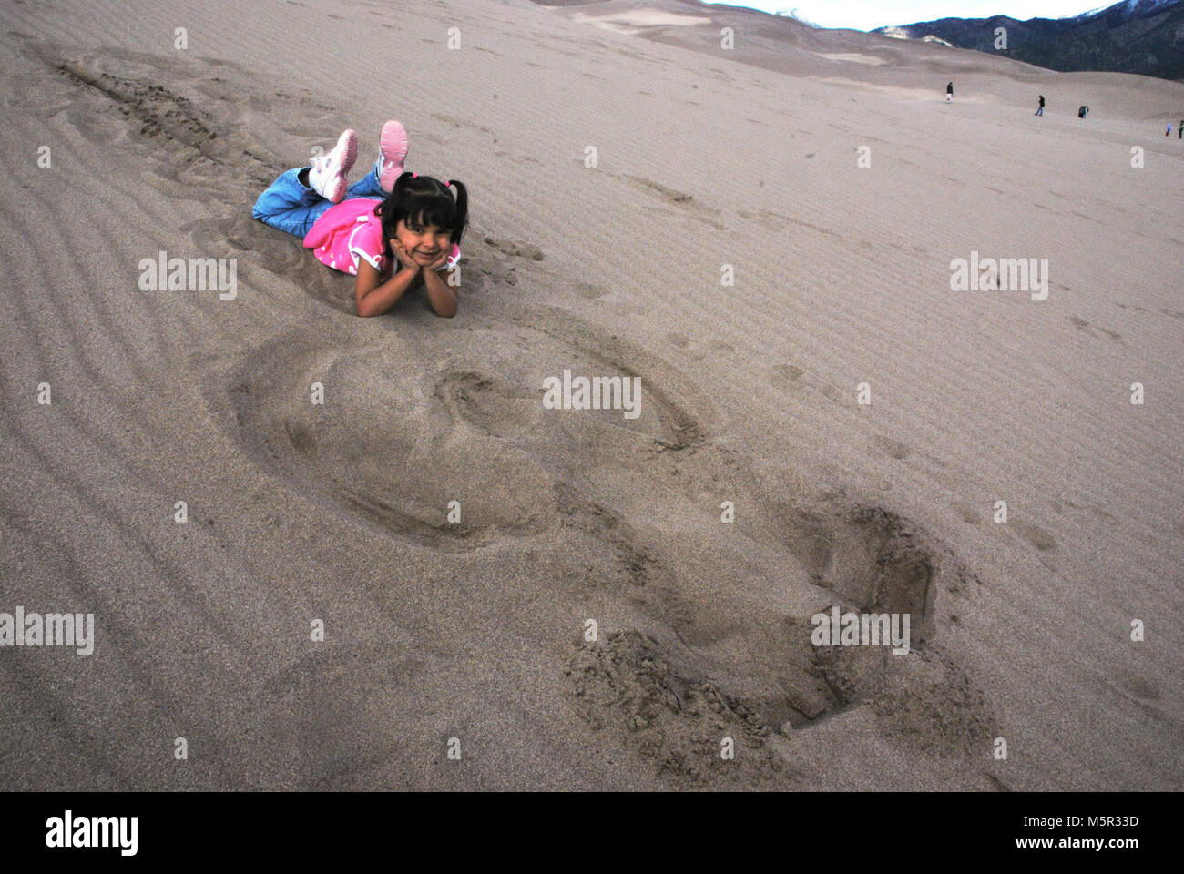 Girl With Her Finished Sand Angel Stock Photo - Alamy