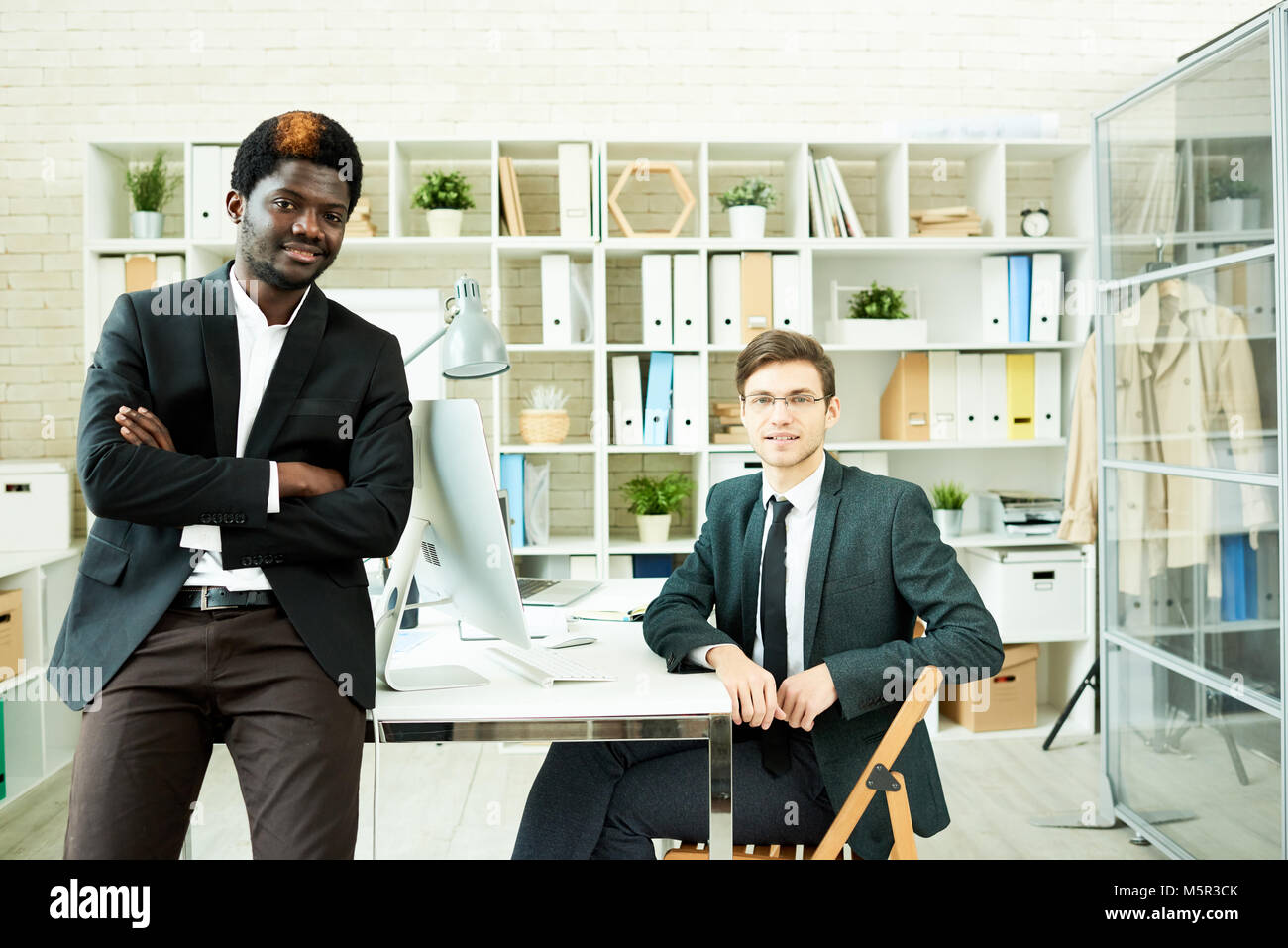 Multi-ethnic team of white collar workers wearing stylish suits posing ...
