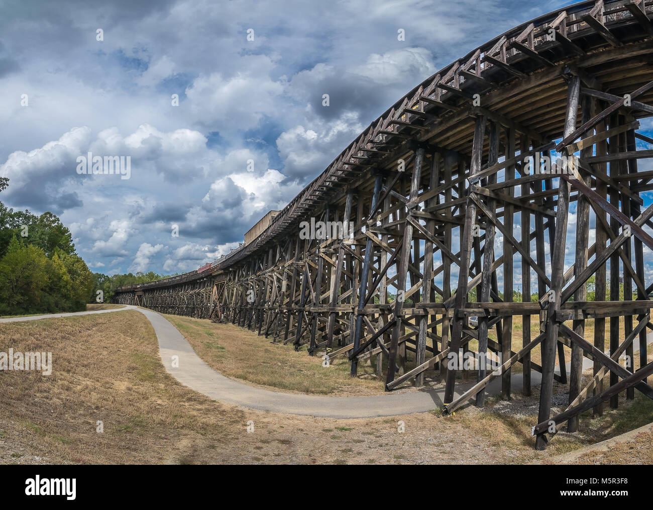 A raised railroad track just before it crosses the river Stock Photo ...