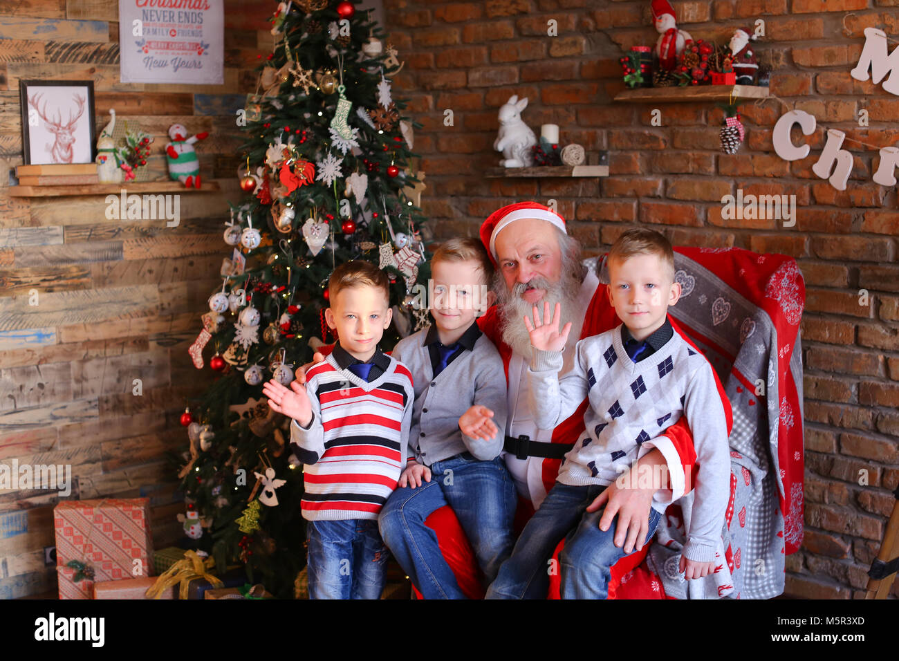 Three boys brothers make wishes to Santa Claus and send greeting Stock ...
