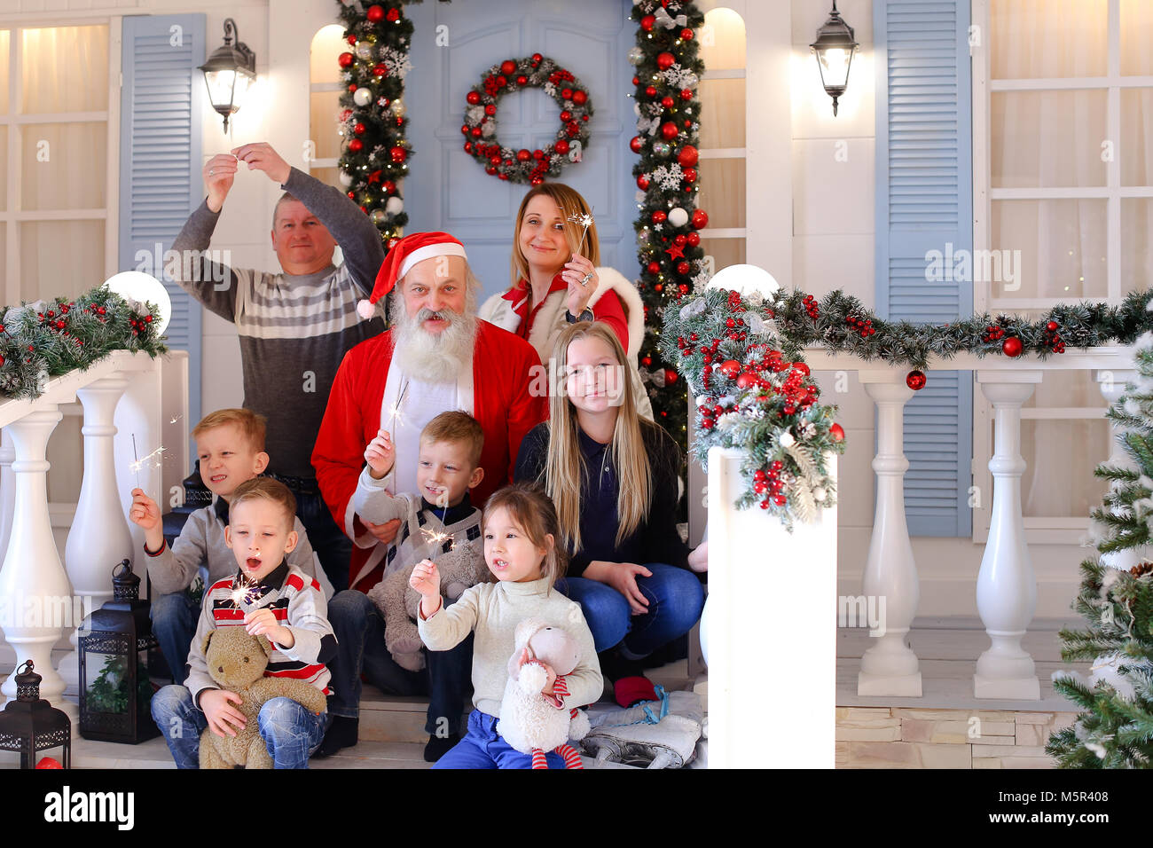 Happy big family celebrating Christmas with Santa Claus Stock Photo - Alamy
