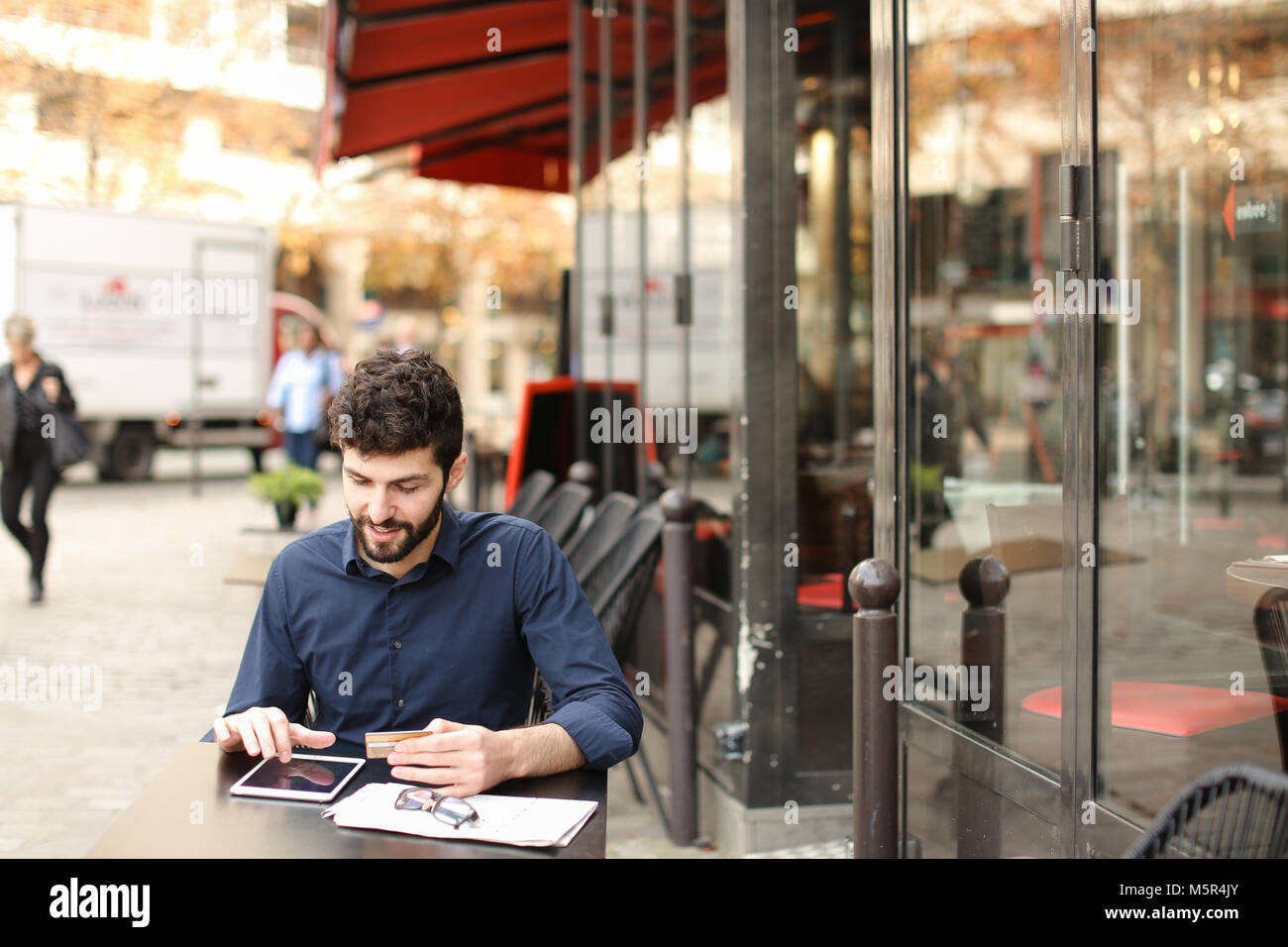 Cheerful football fun supporting team with tablet at street caf Stock ...