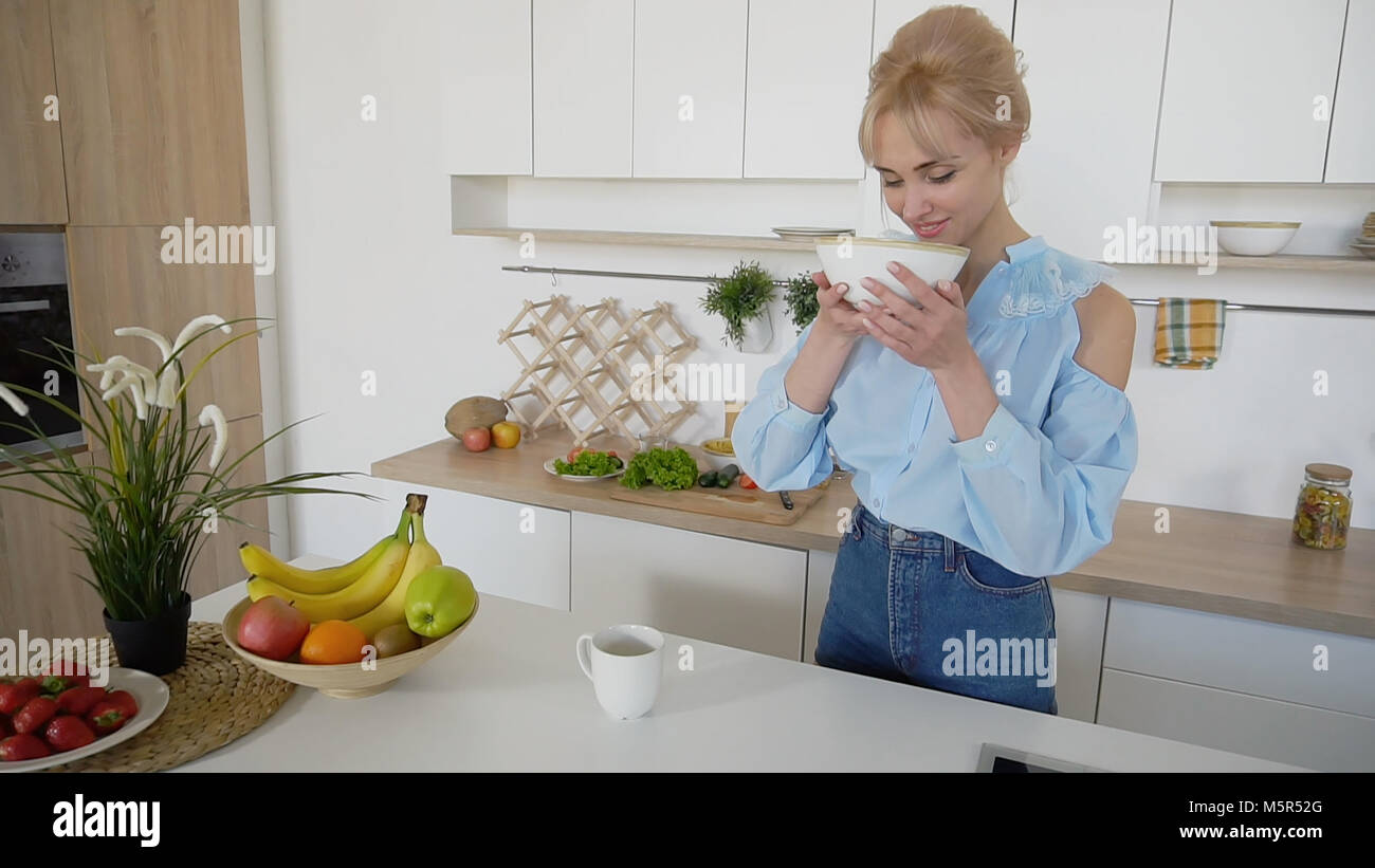 Stylish girl cooks posing for breakfast in morning, standing at Stock ...