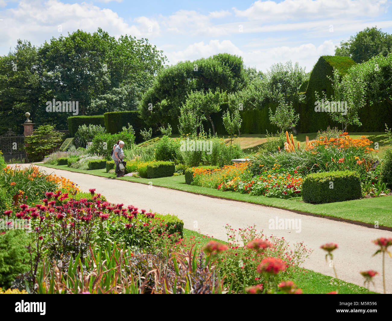 Tourists Flower gardens at the historic medieval grounds and buildings ...