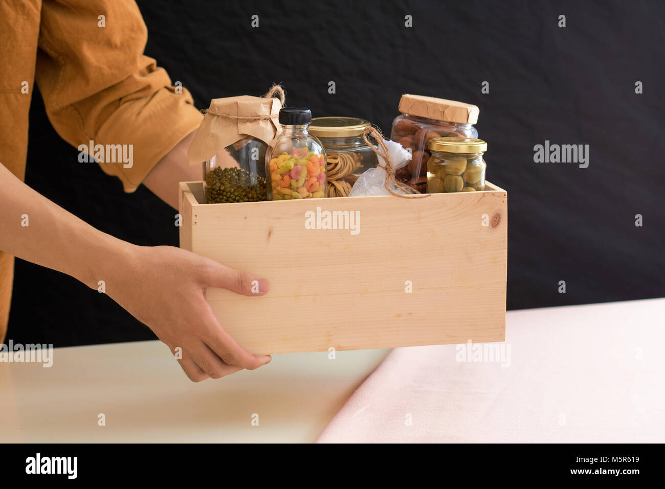 Volunteer with box of food for poor. Donation concept Stock Photo - Alamy