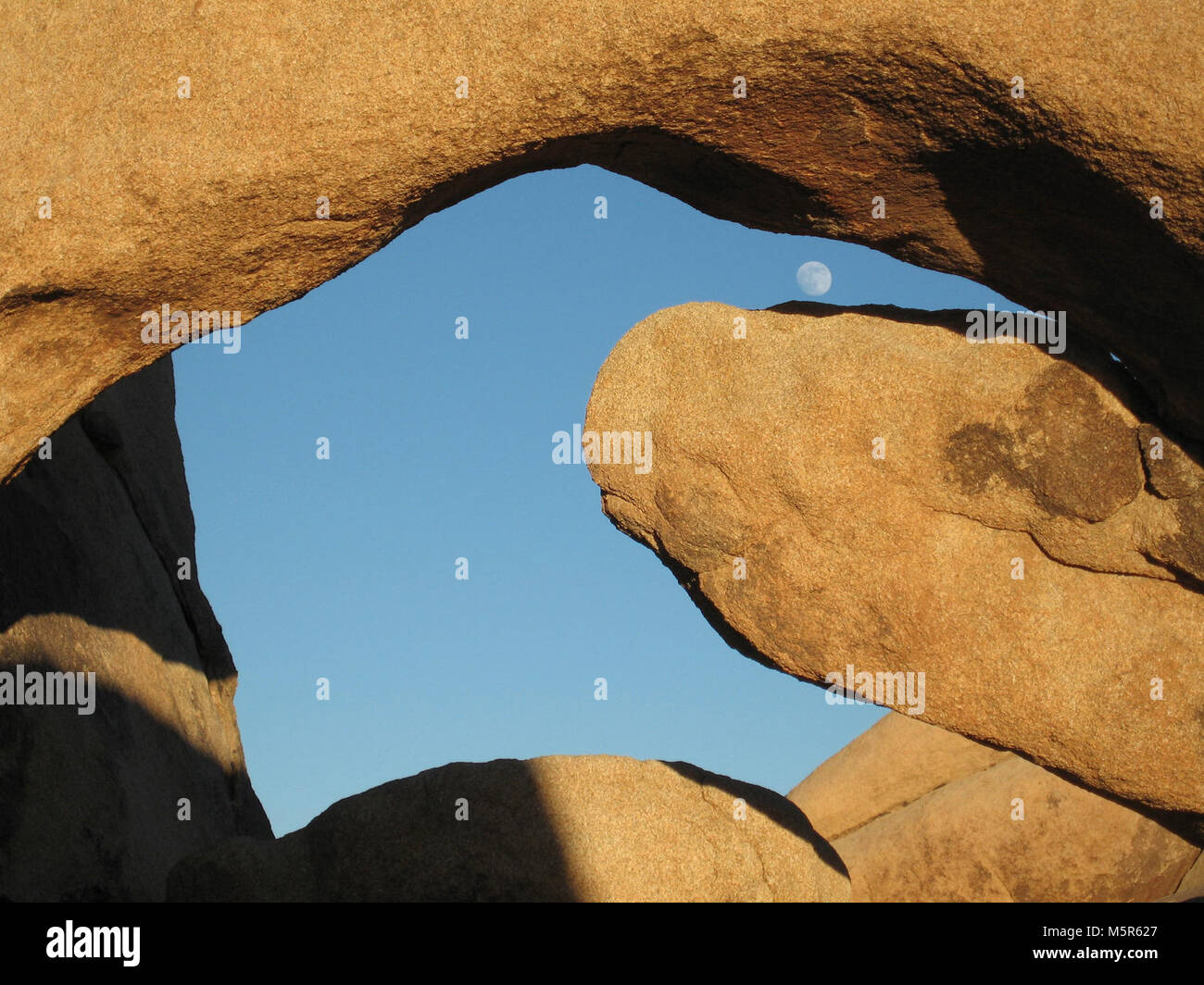 Moon & Arch Rock Stock Photo - Alamy