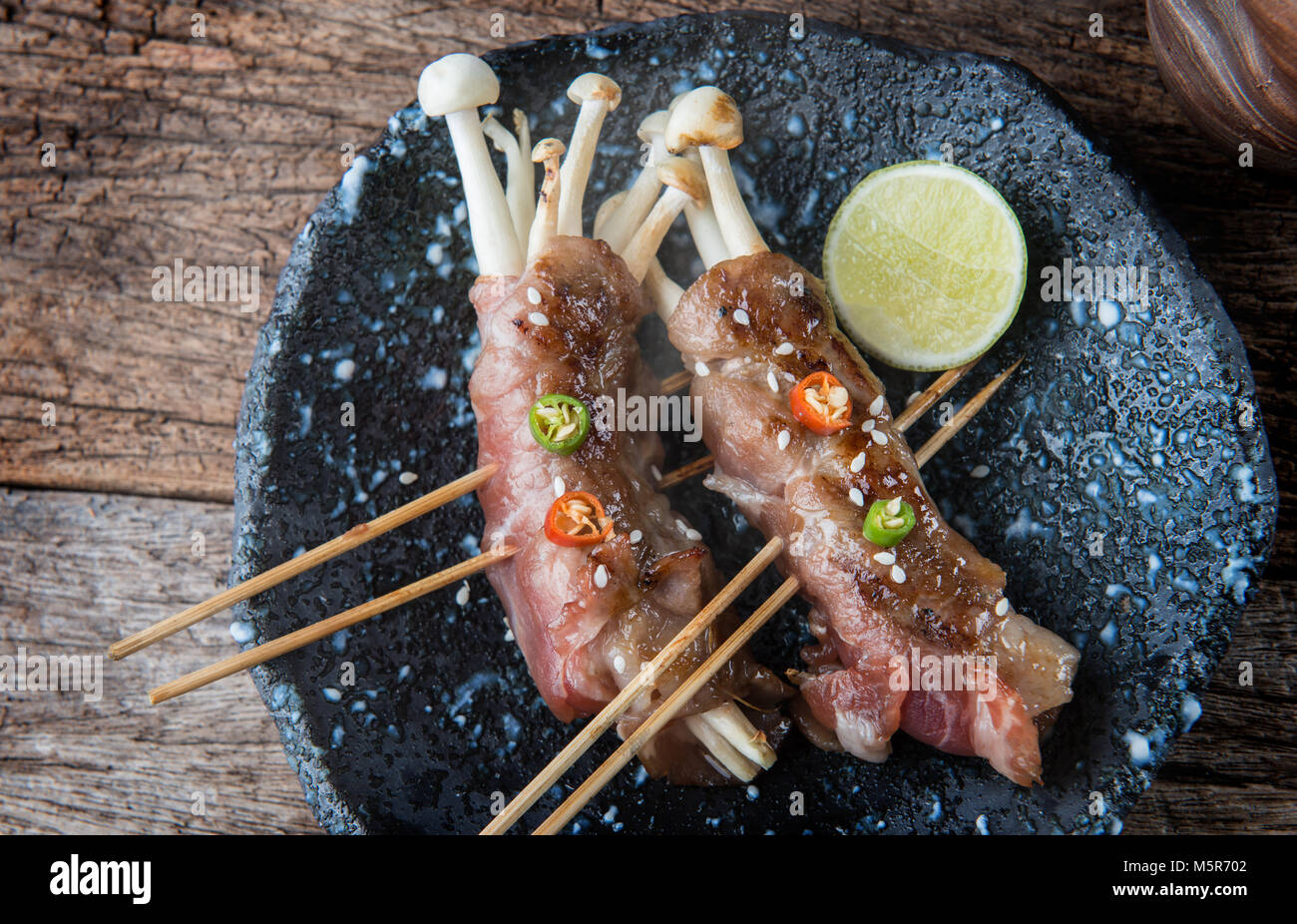 Slice beef roll with mashroom and spicy topping serve in Japanese style ...