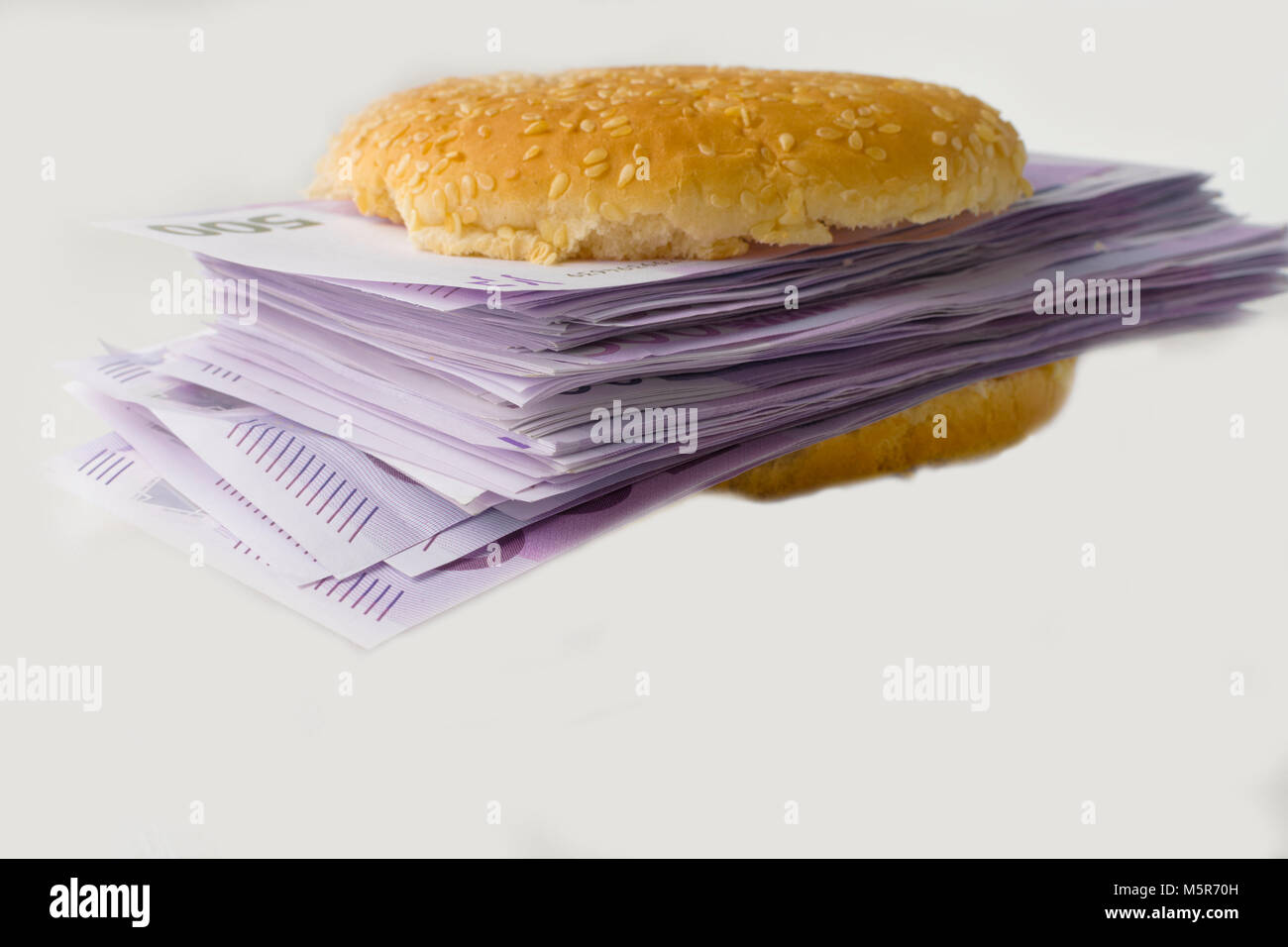 hamburger filled with euro money Stock Photo - Alamy
