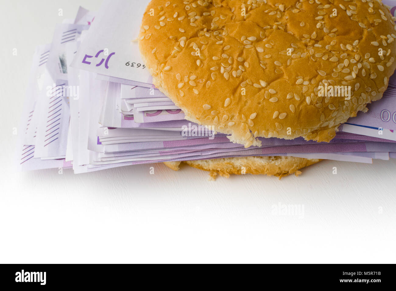hamburger filled with euro money Stock Photo - Alamy