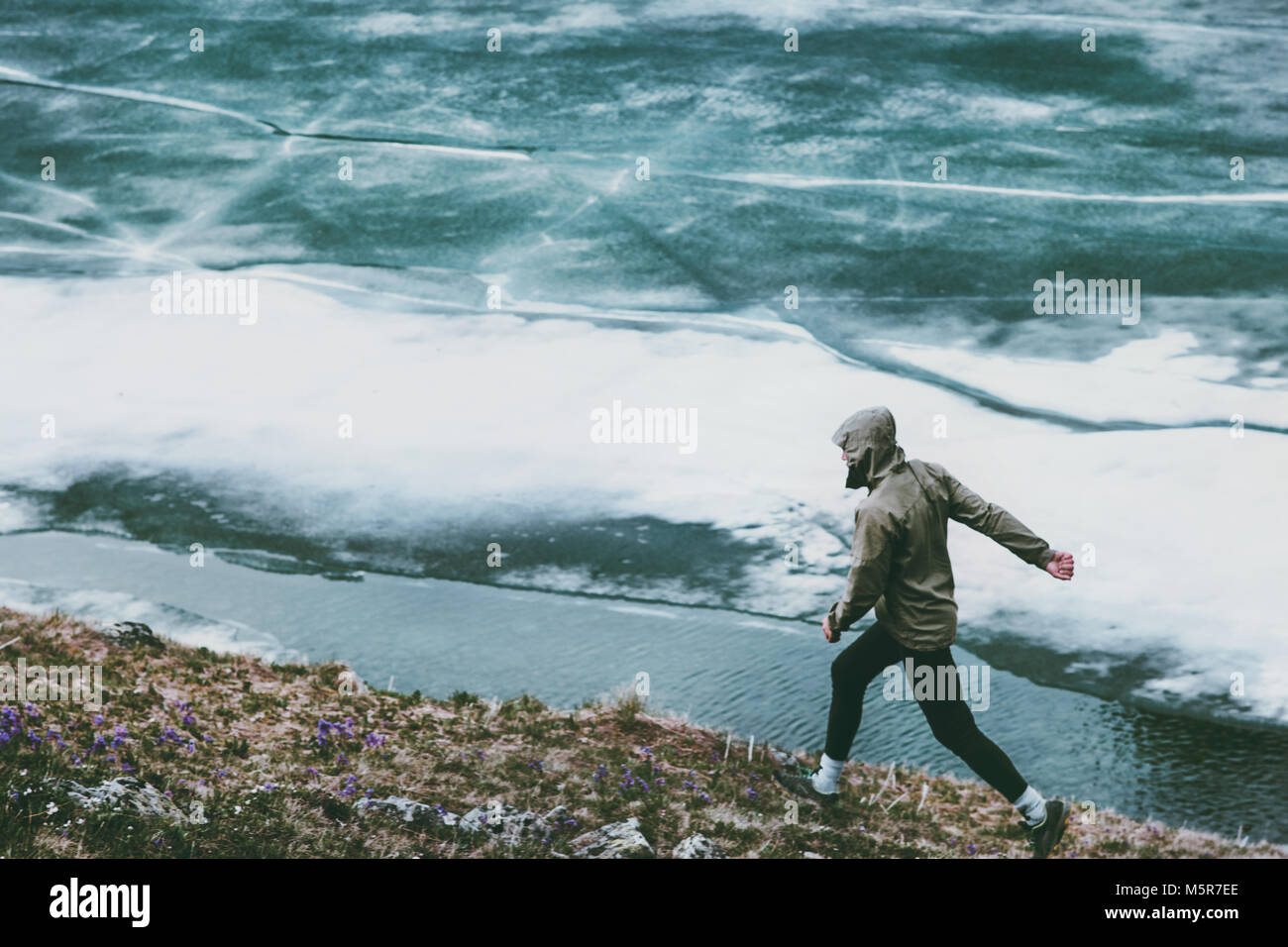 Active Man running at frozen lake Travel adventure healthy lifestyle ...